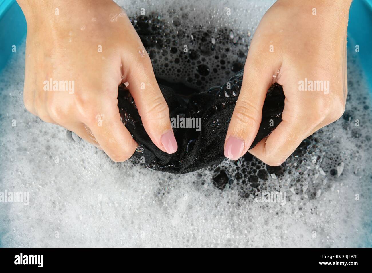 Female hands washing clothes in basin Stock Photo - Alamy