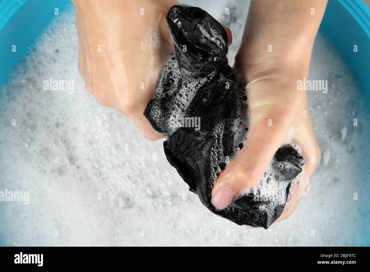 Female hands washing clothes in basin Stock Photo - Alamy