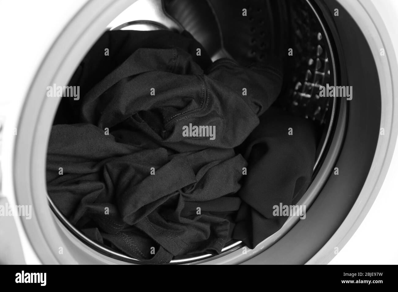 Washing machine and clothes, close up Stock Photo - Alamy