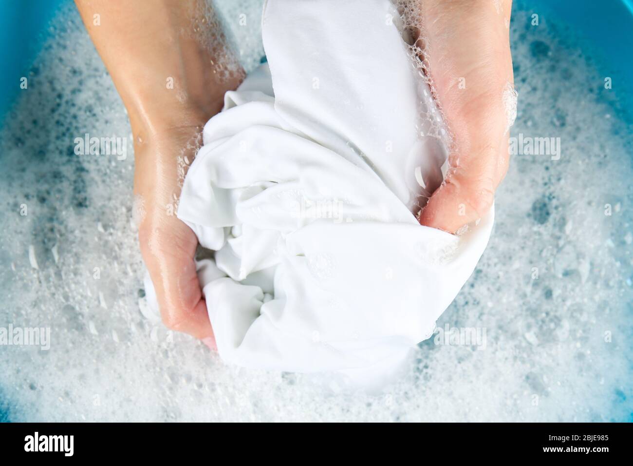 Female hands washing clothes in basin Stock Photo - Alamy