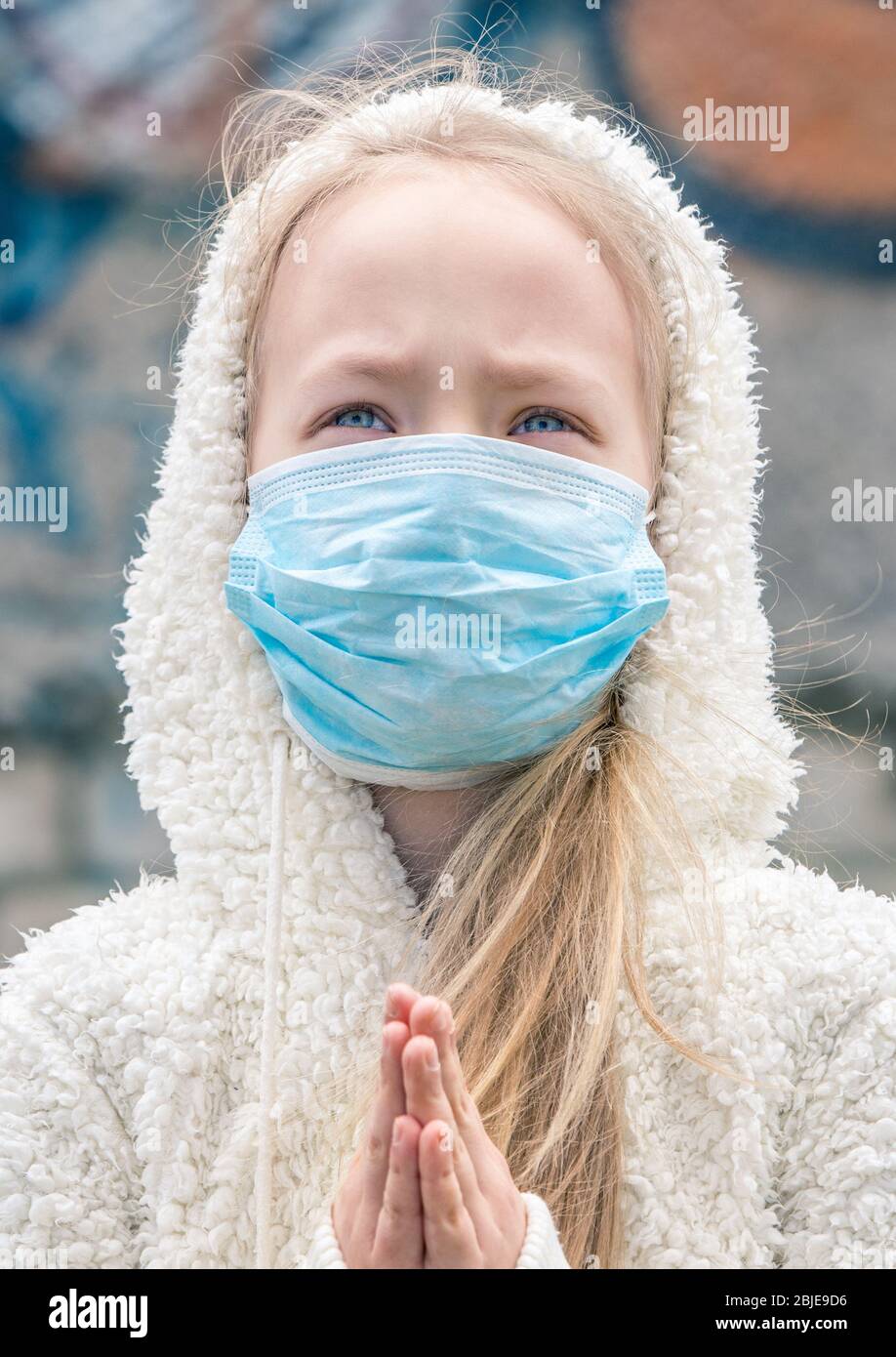 Child girl wearing respirator mask asks for help Stock Photo - Alamy