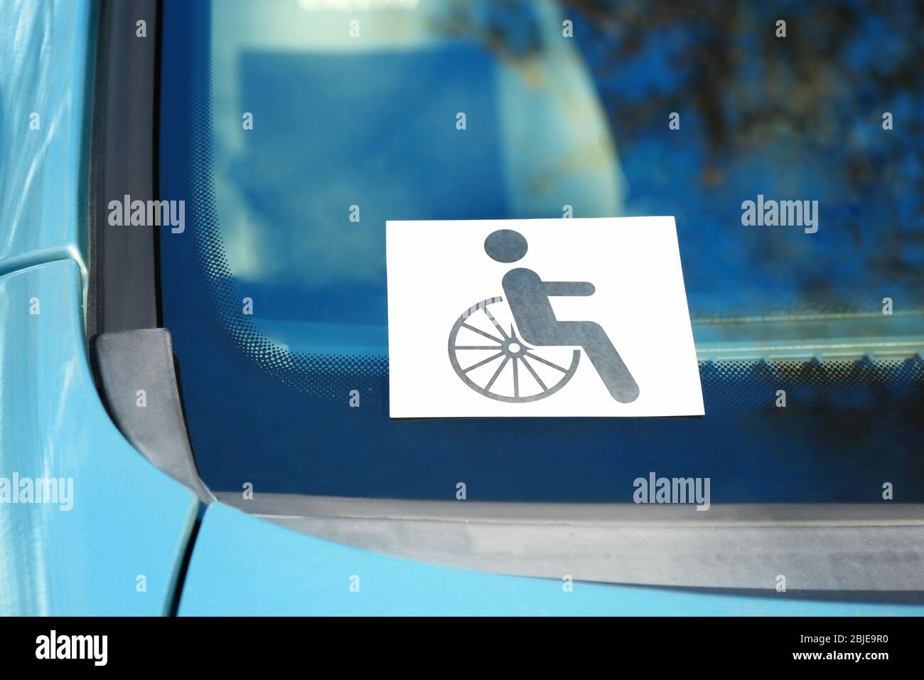 Symbol of handicapped on car windshield, closeup Stock Photo - Alamy