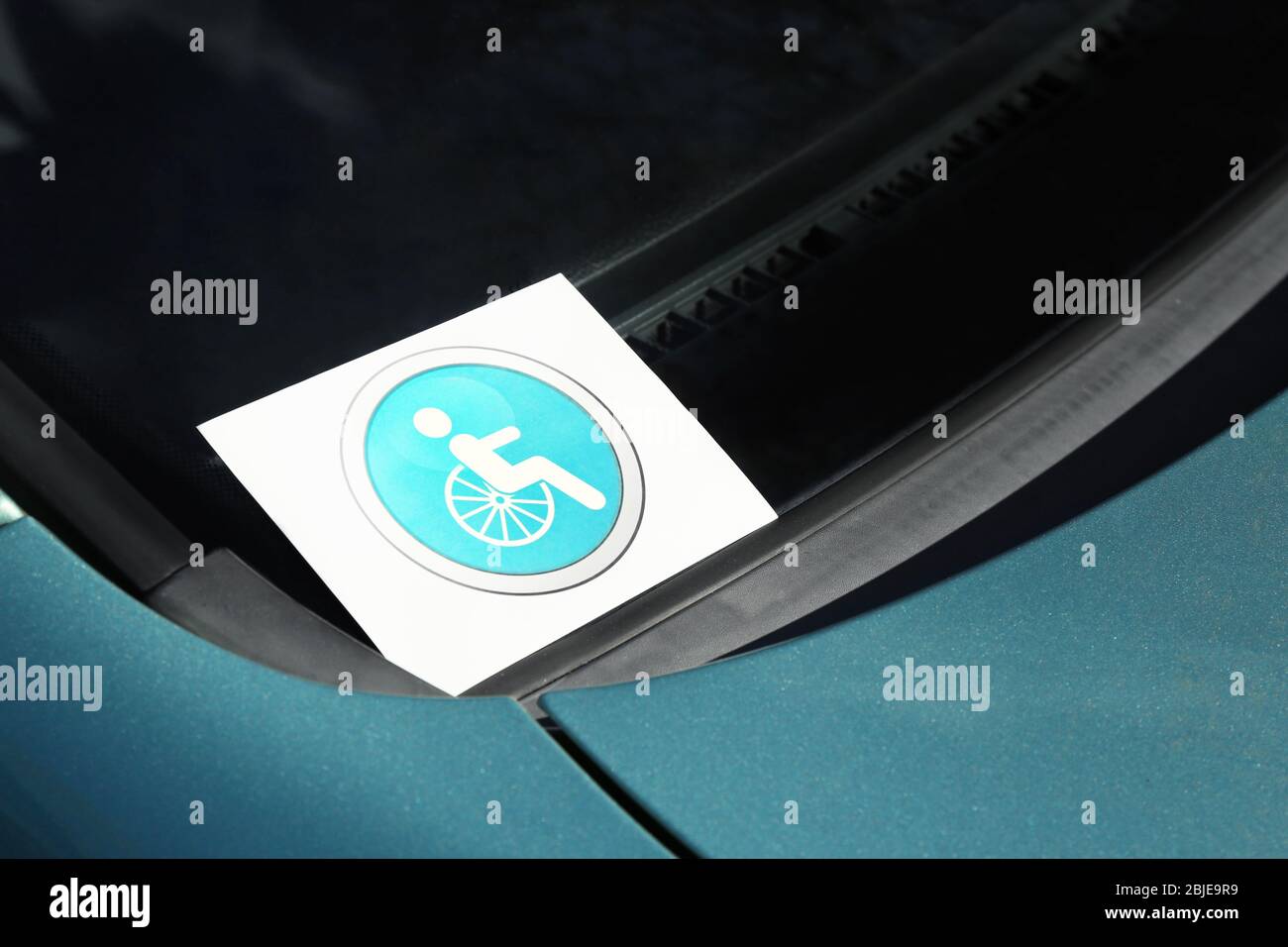 Symbol of handicapped on car windshield, closeup Stock Photo - Alamy