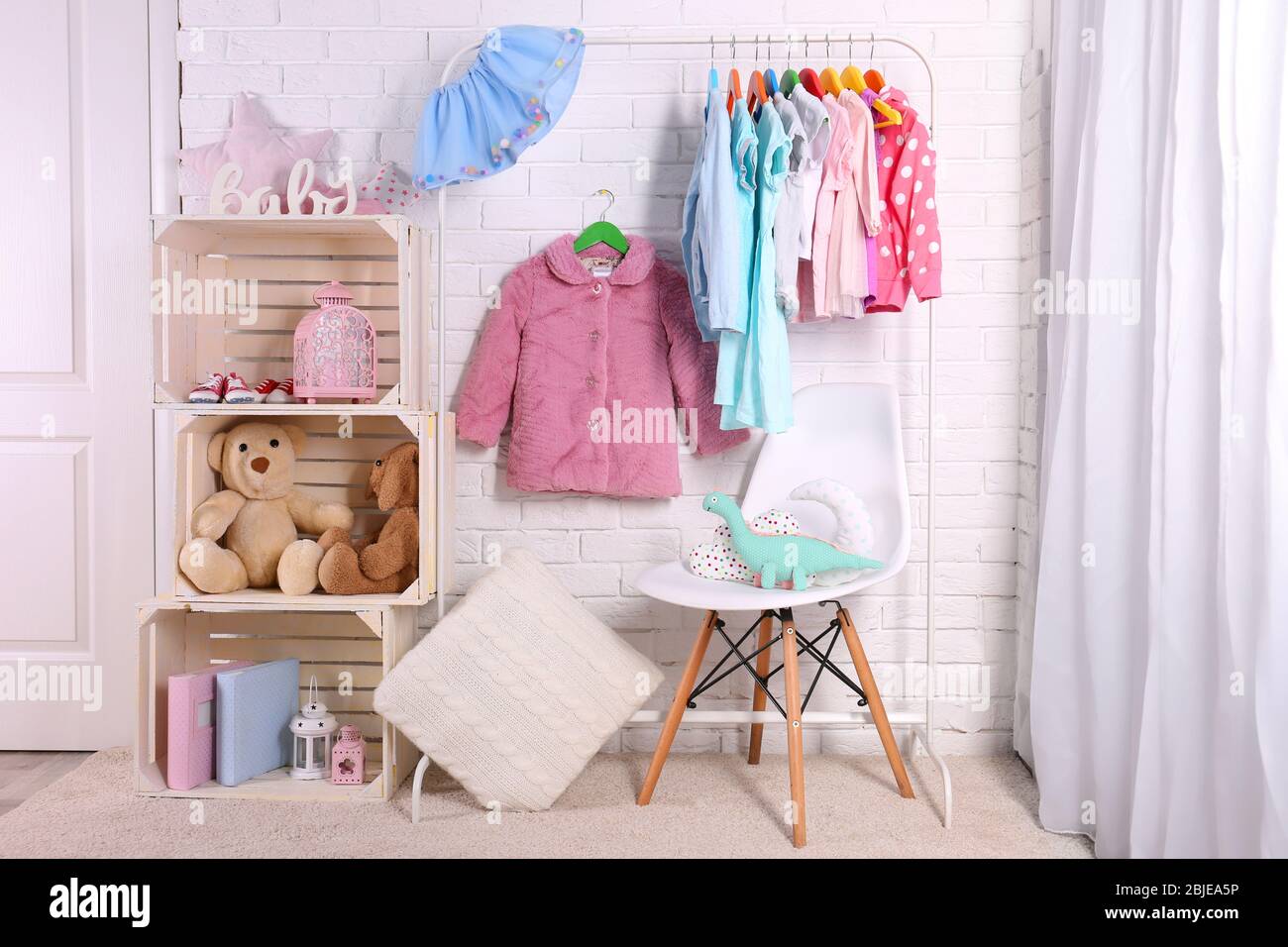 Children clothing on hanger stand in dressing room Stock Photo - Alamy
