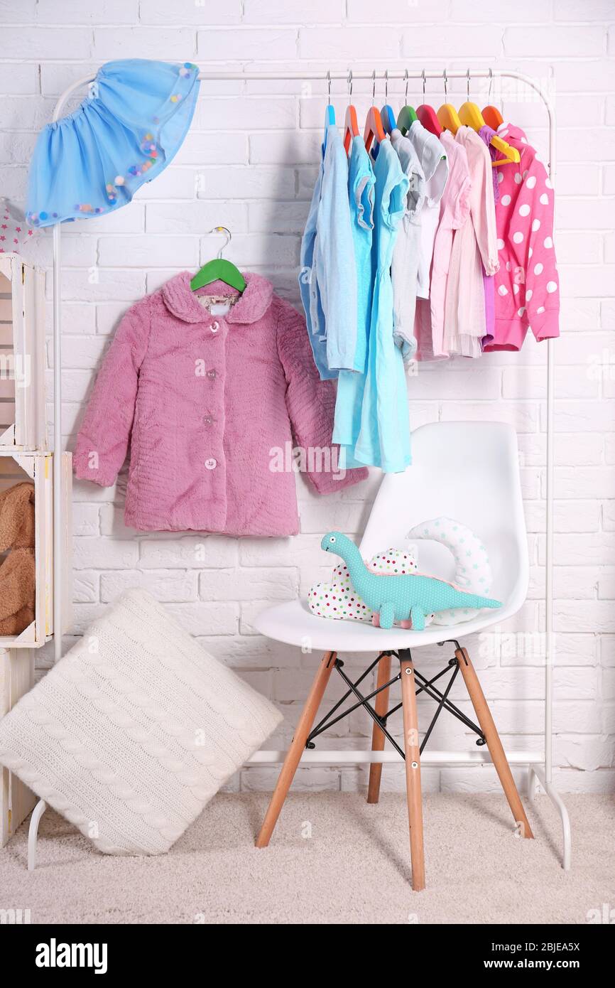 Children clothing on hanger stand in dressing room Stock Photo - Alamy
