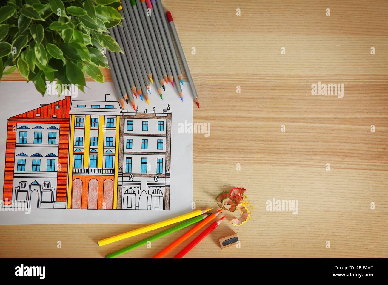 Composition of colouring picture and pencils on wooden table Stock ...