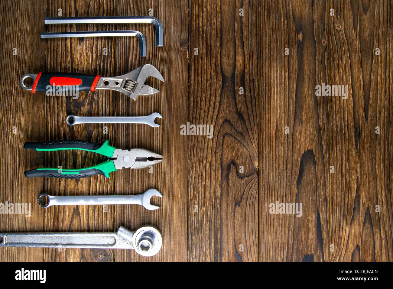 Set of tools over a wood panel with space for text. Top views with ...