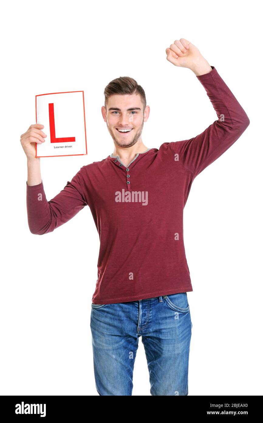 Young man with learner driver sign on white background Stock Photo - Alamy