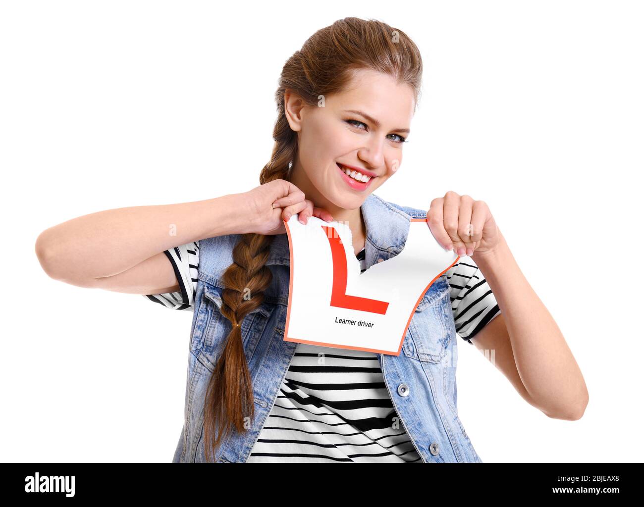 Young woman tearing learner driver sign on white background Stock Photo ...