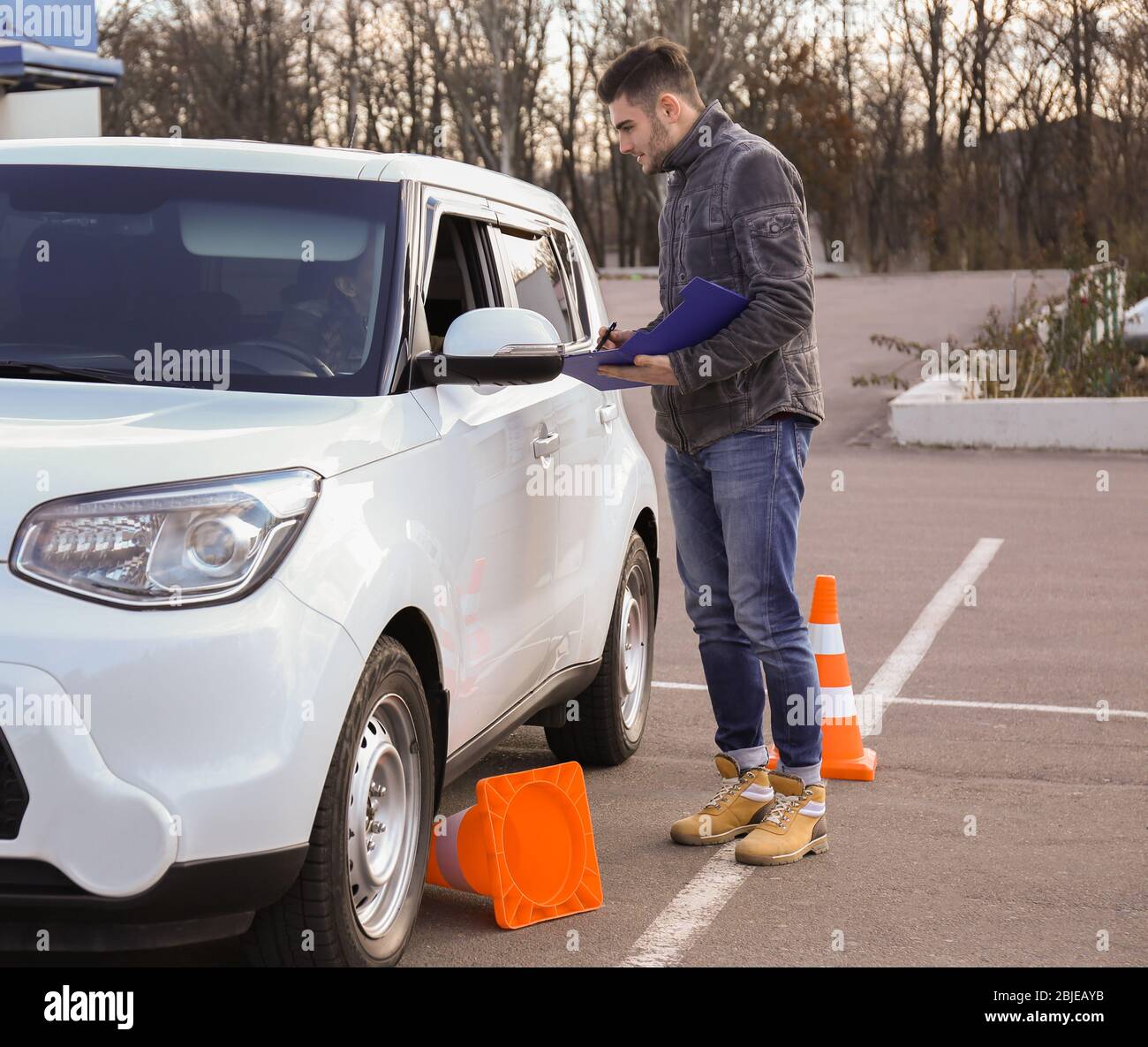 Young woman passing driving license exam outdoors Stock Photo - Alamy