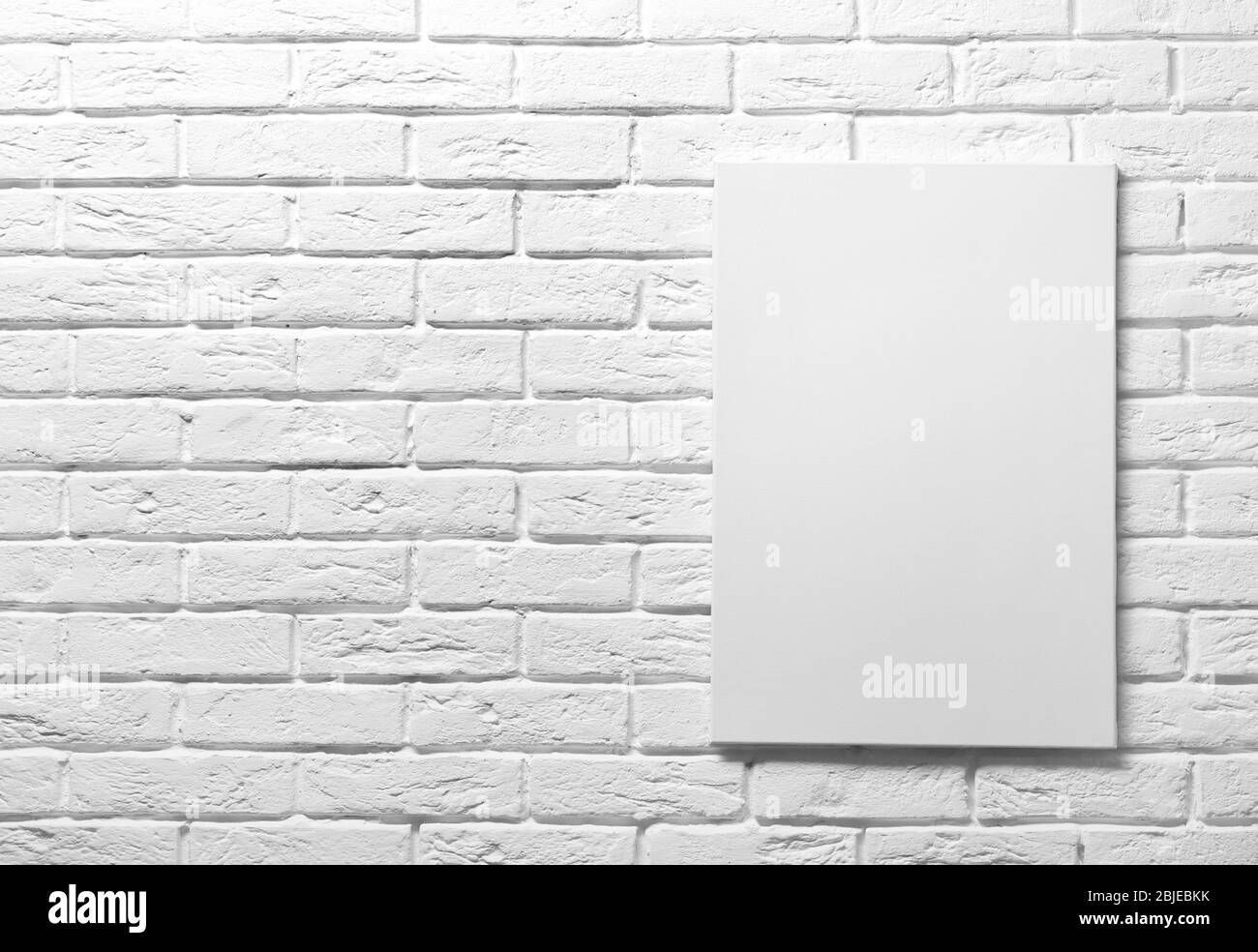 Empty canvas on white brick wall background Stock Photo - Alamy