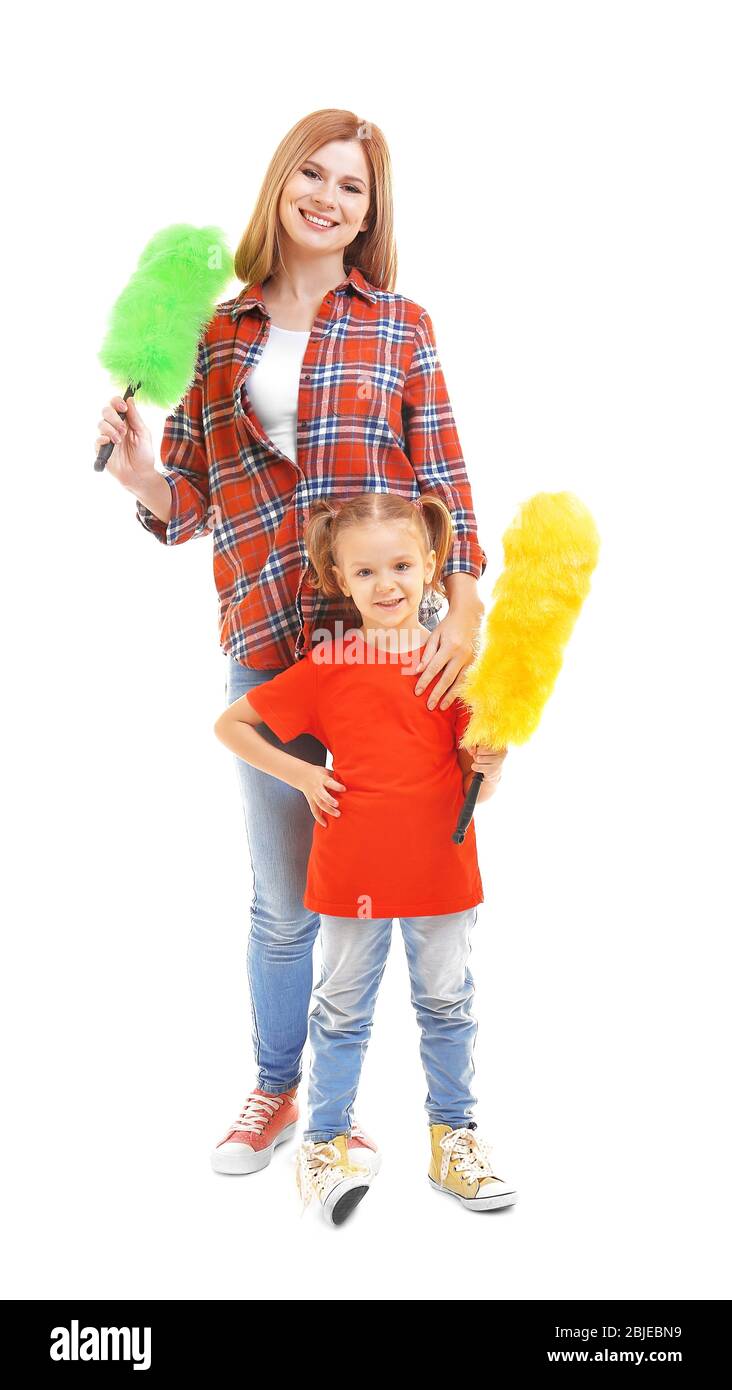 Little girl and her mother with dusters on white background Stock Photo ...
