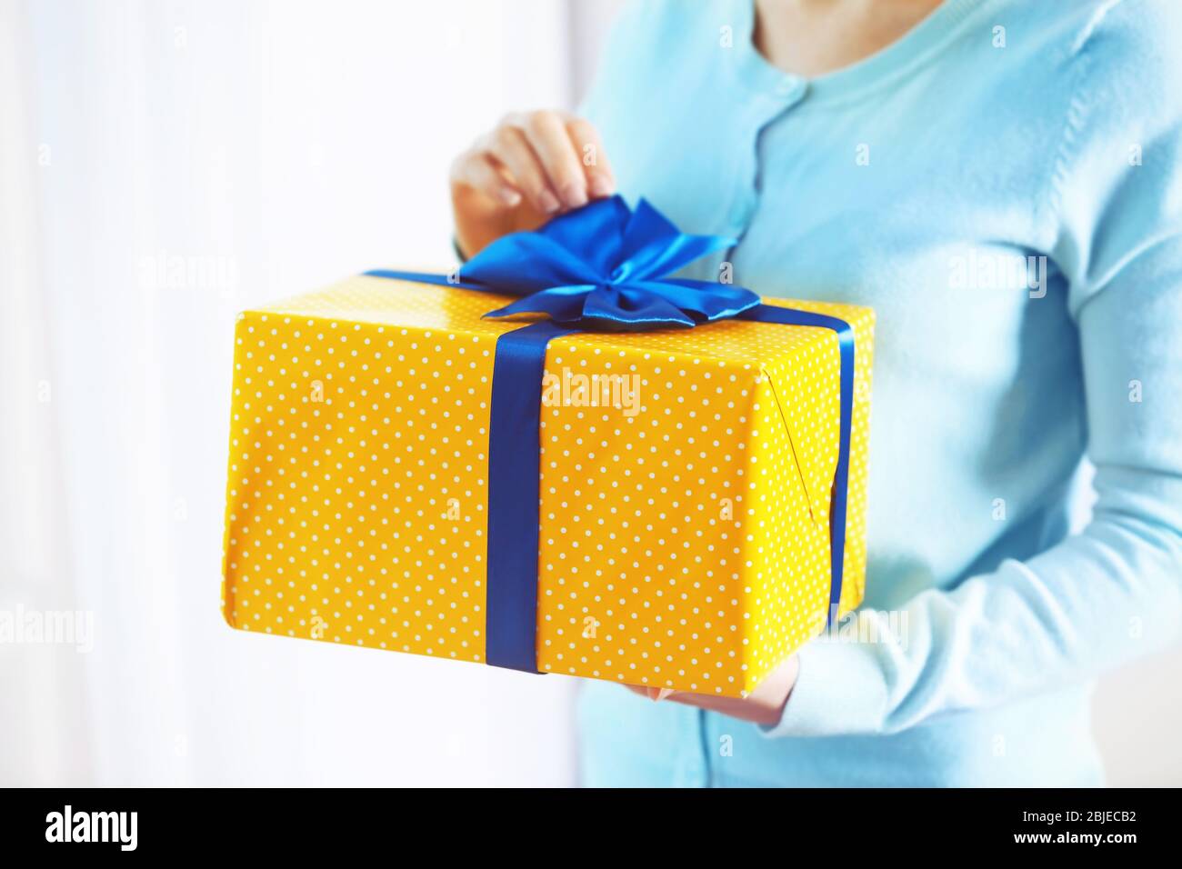 Female hands holding gift box, closeup Stock Photo - Alamy