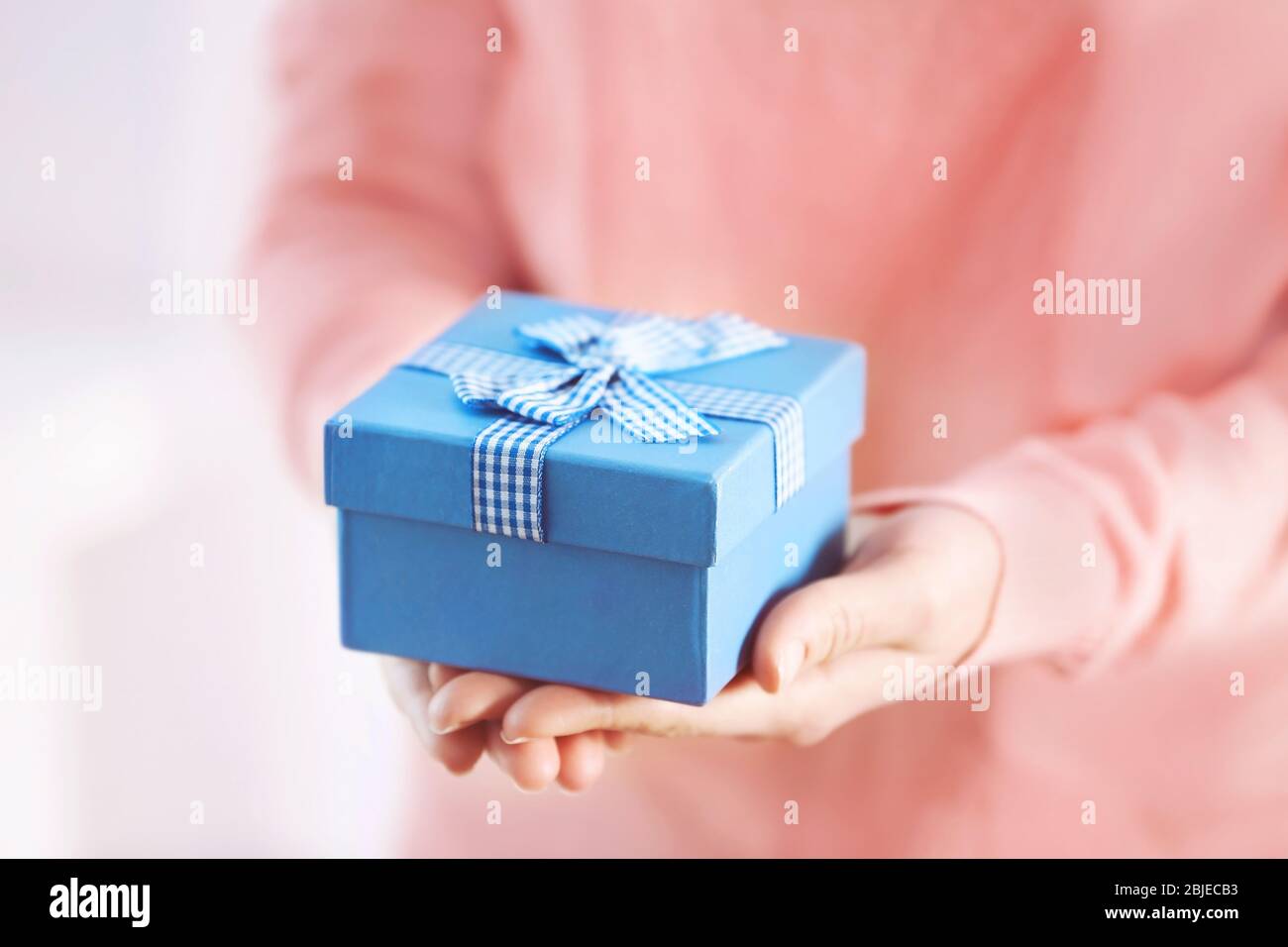 Female hands holding gift box, closeup Stock Photo - Alamy
