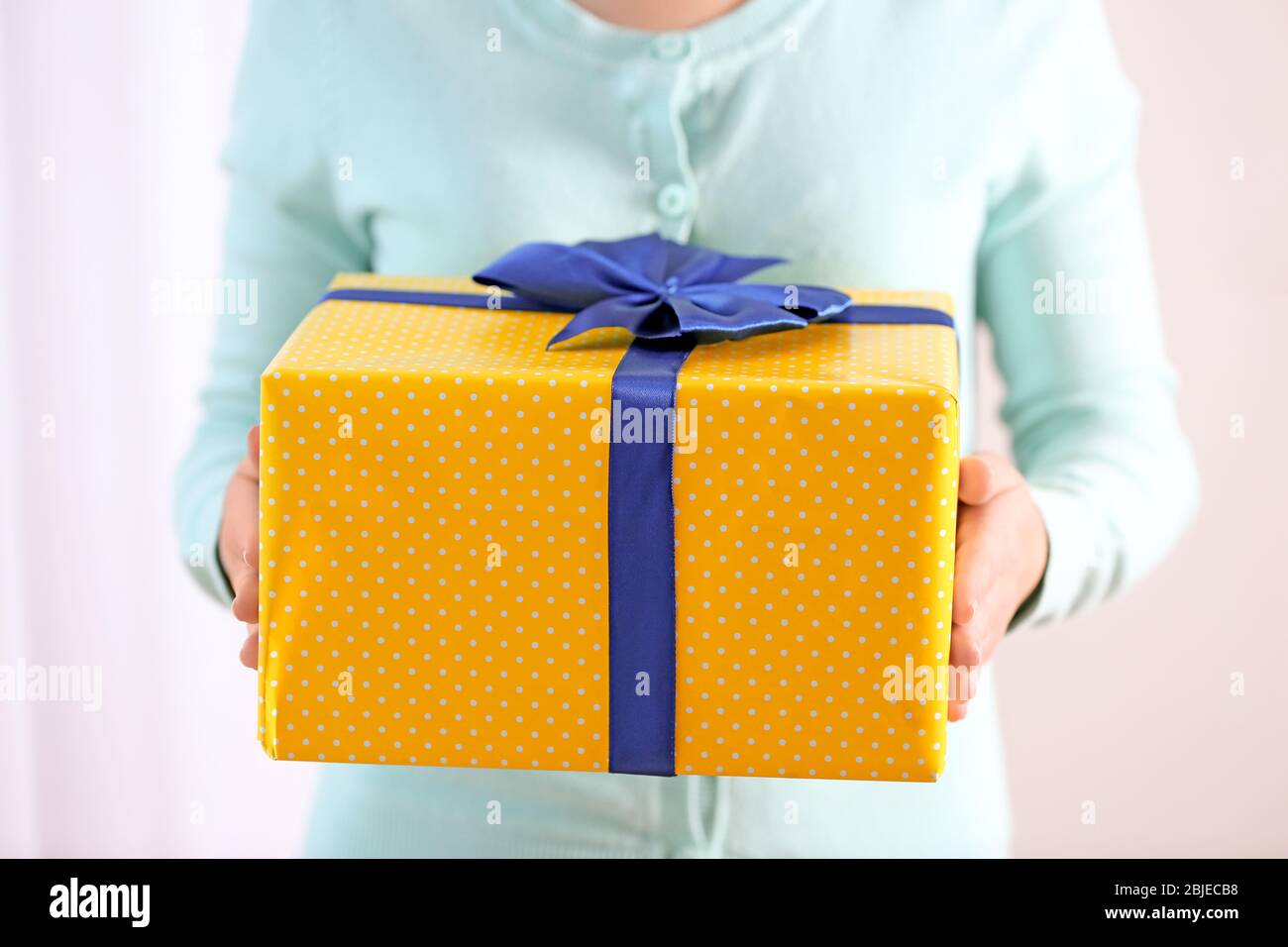 Female hands holding gift box, closeup Stock Photo - Alamy