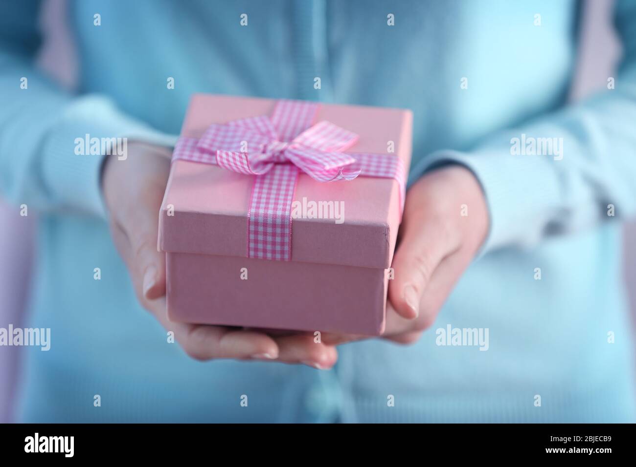 Female hands holding gift box, closeup Stock Photo - Alamy