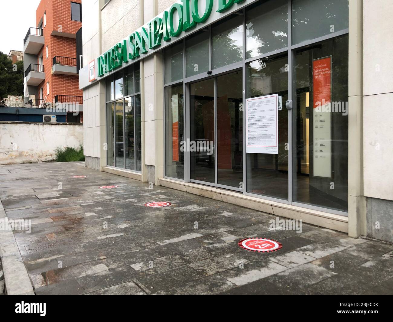Signs printed on pavement informing people to keep 2 meters distance ...
