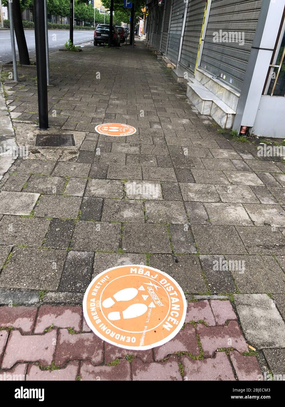 Signs printed on pavement informing people to keep 2 meters distance ...