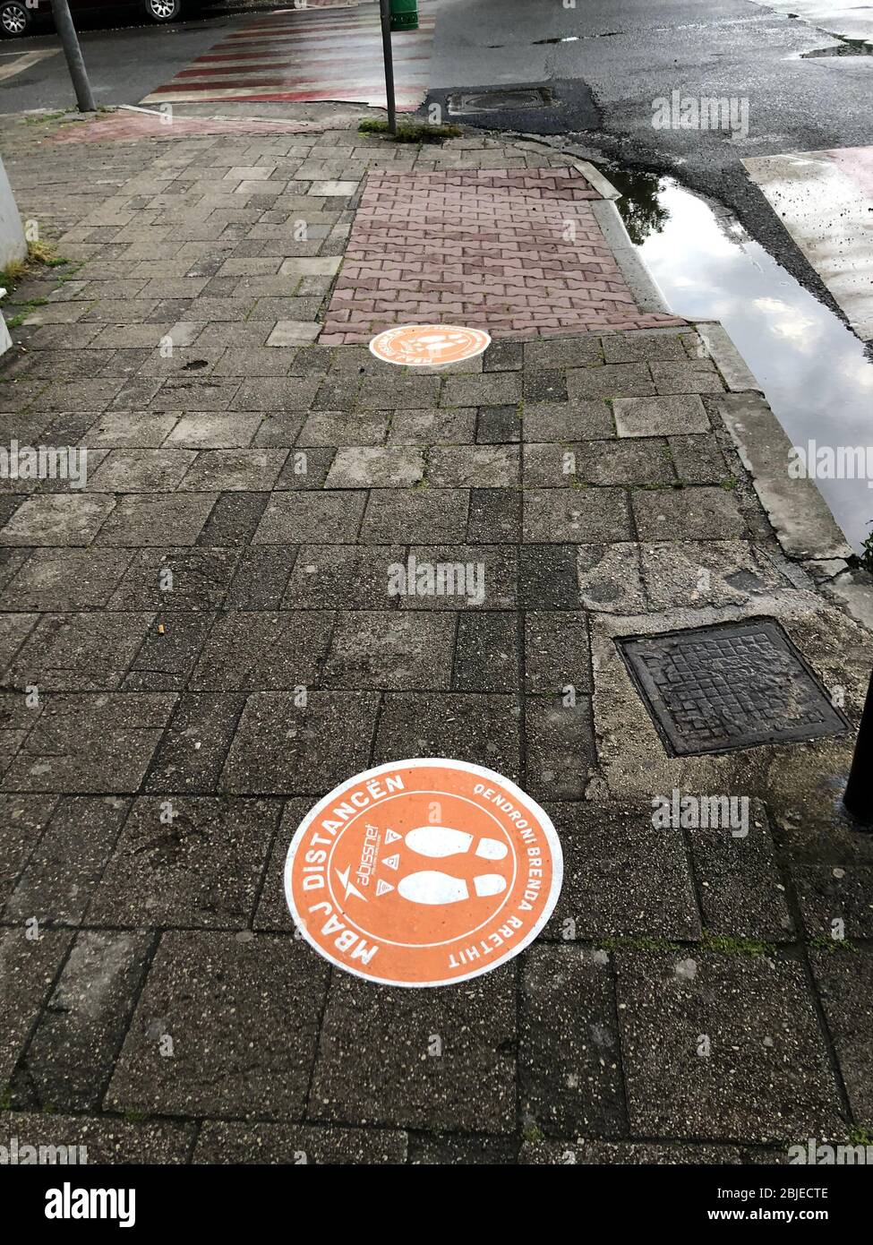 Signs printed on pavement informing people to keep 2 meters distance ...