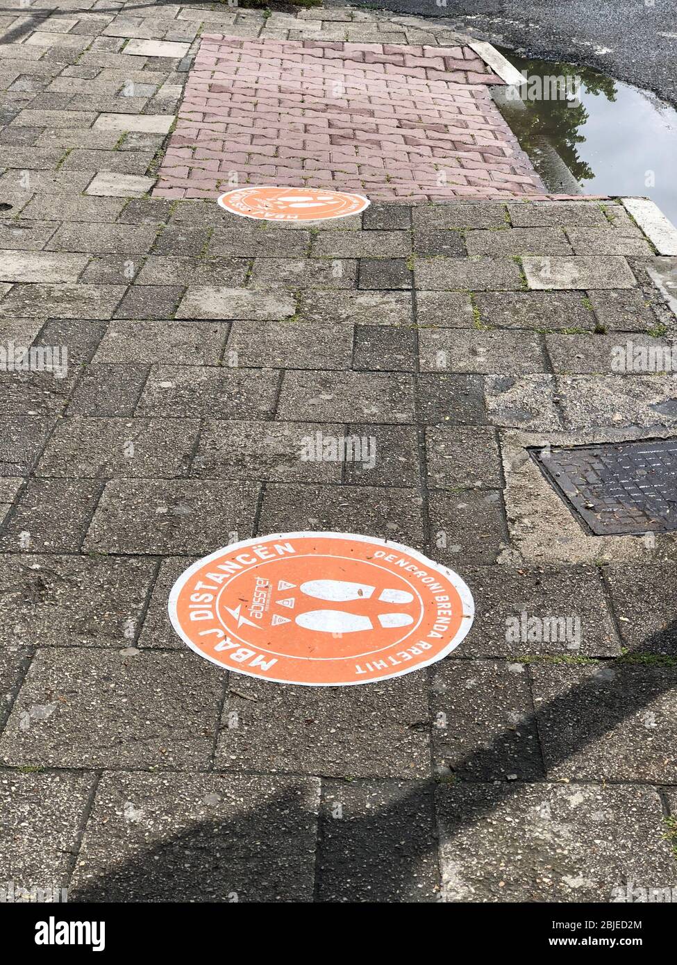 Signs printed on pavement informing people to keep 2 meters distance ...