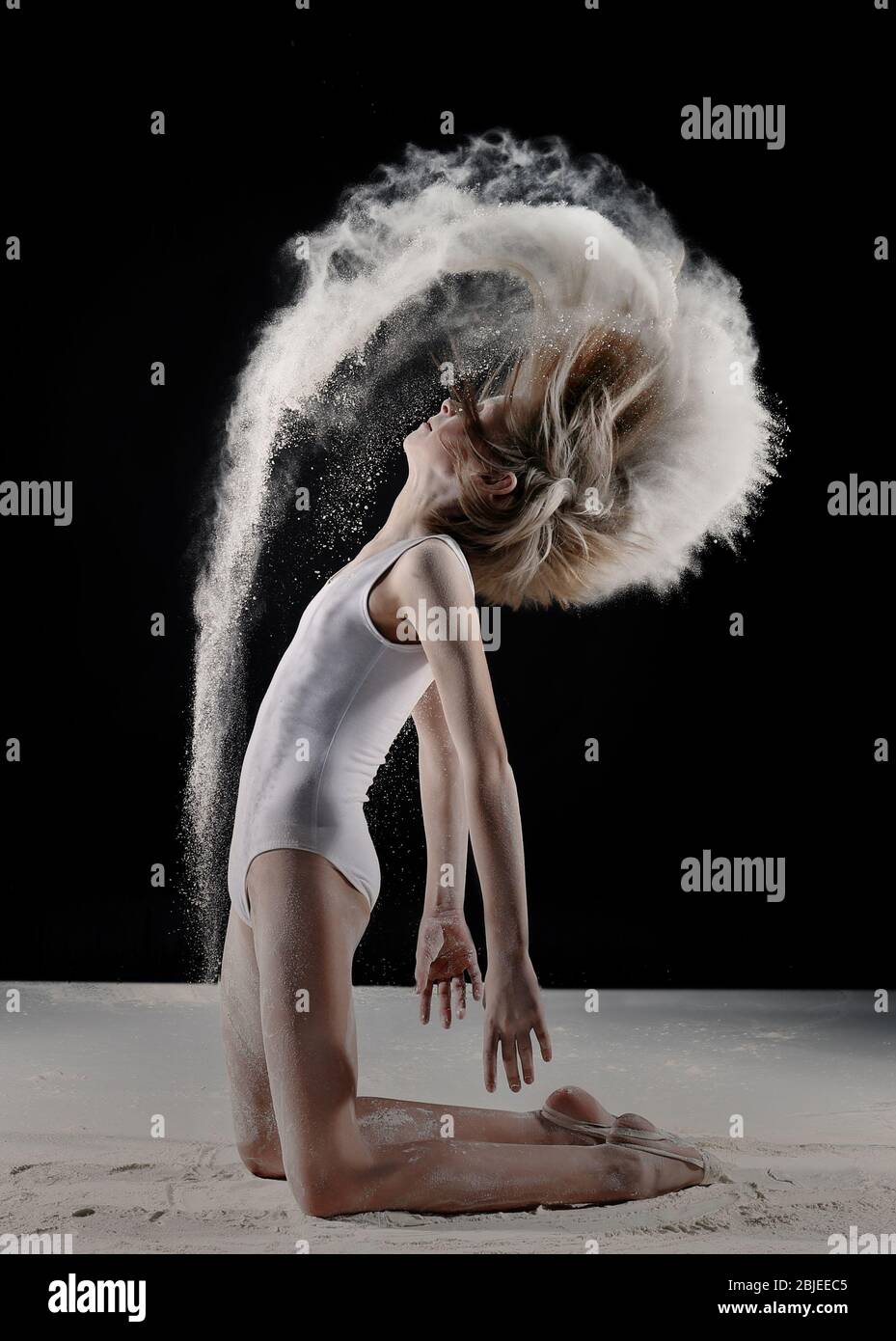 Little cute girl dancing with white powder on black background Stock ...