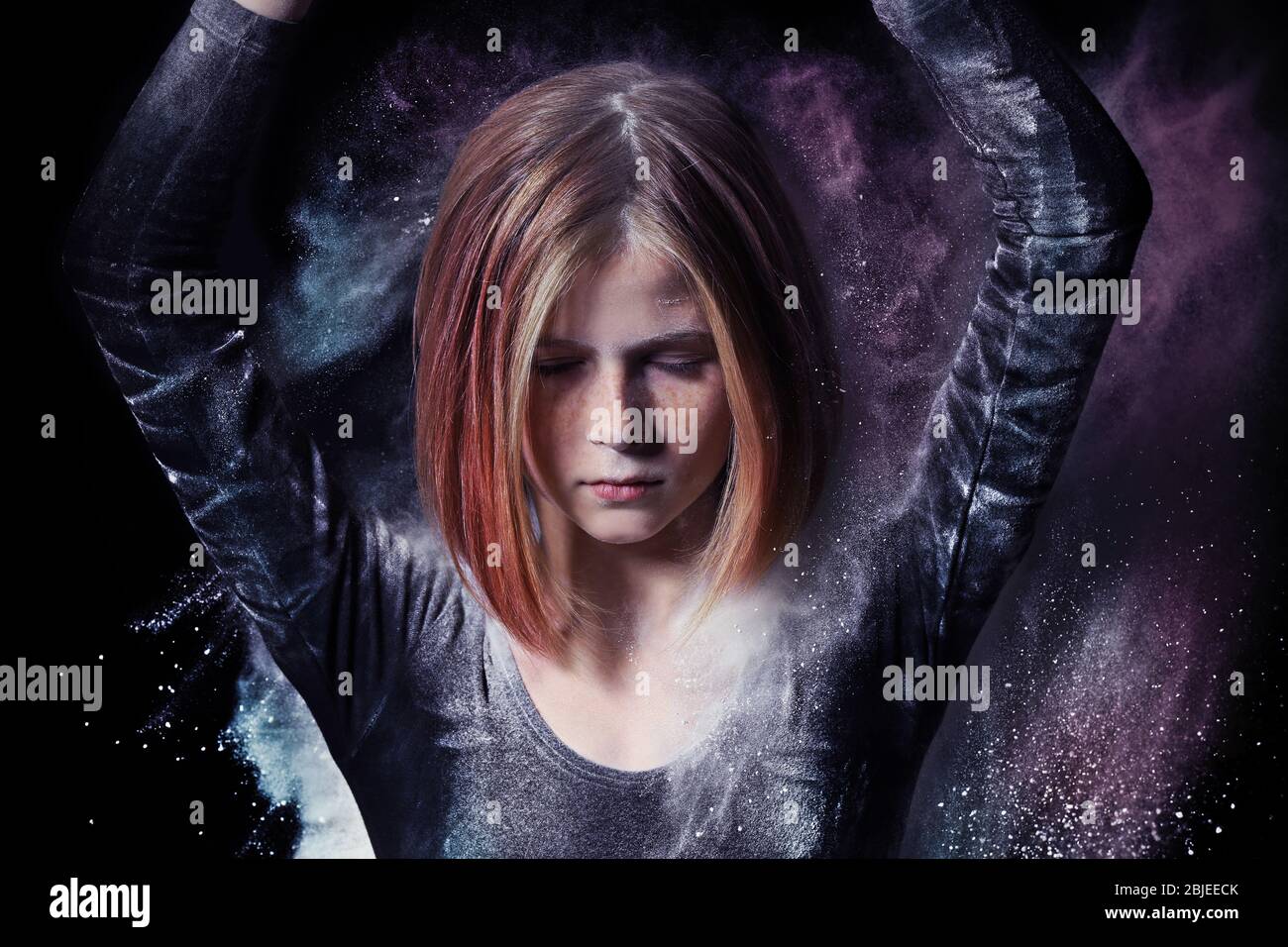 Little cute girl with white powder exploding around her on black ...