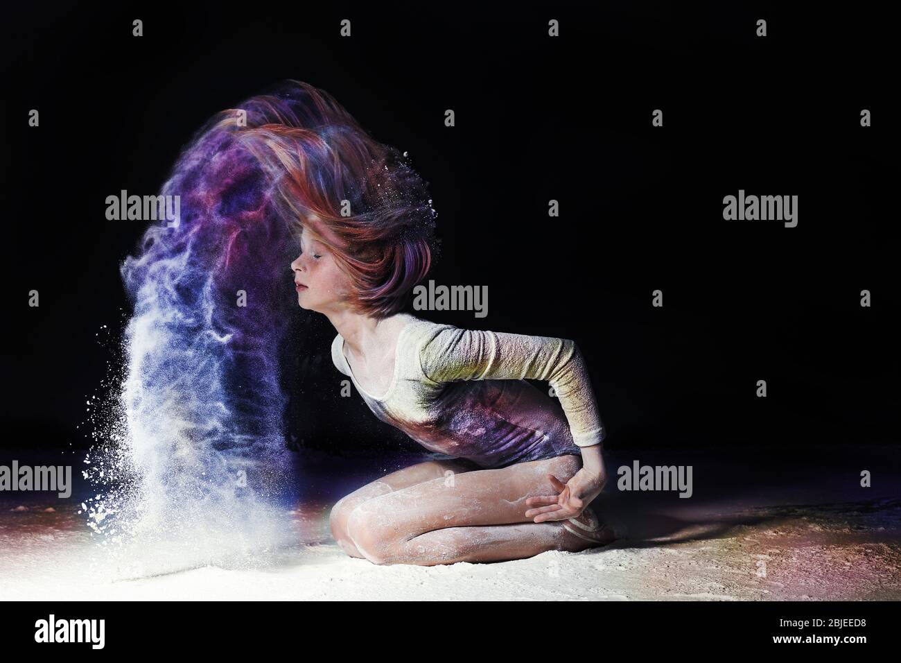 Little cute girl dancing with white powder on black background Stock ...