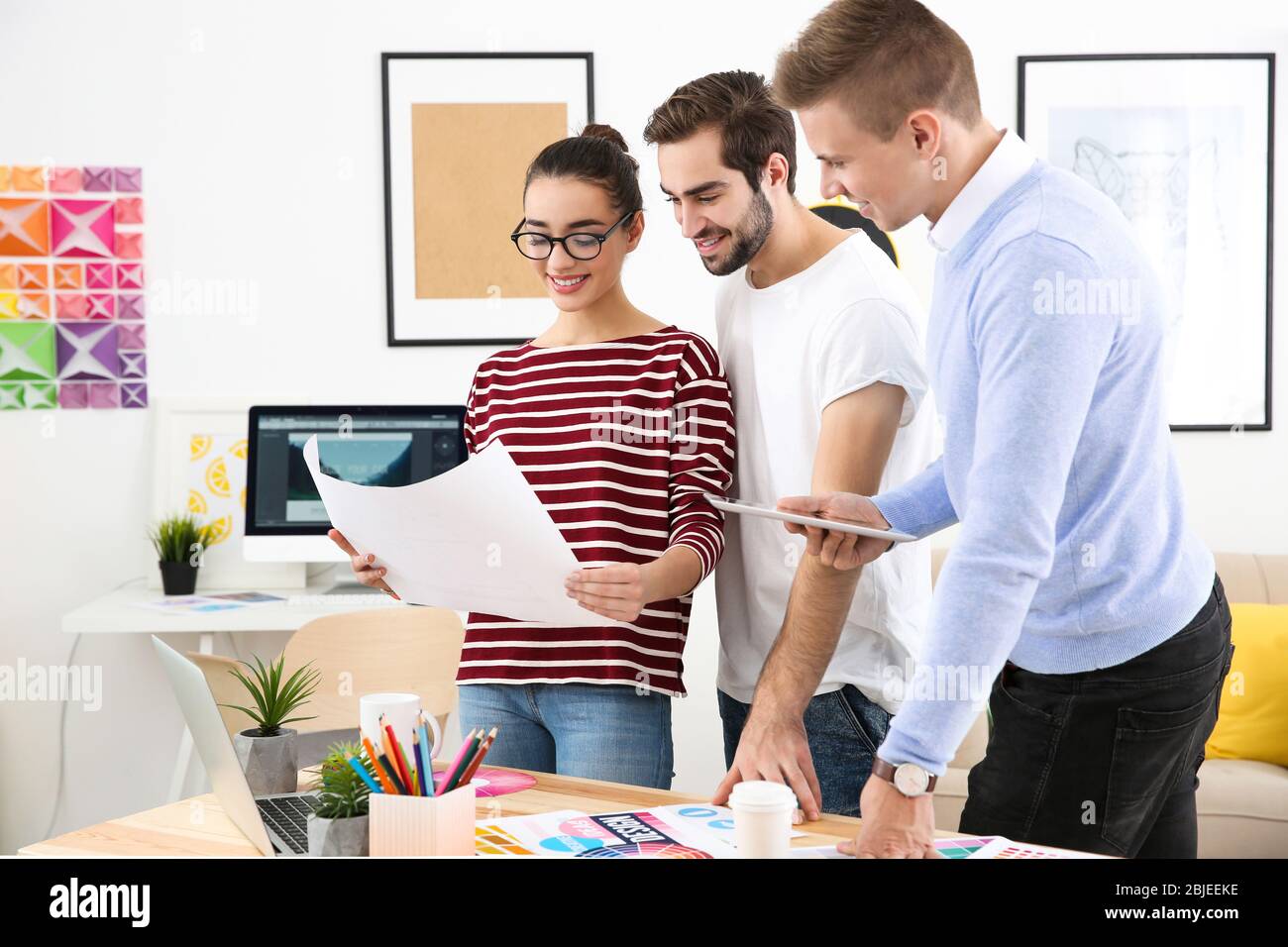 Three young designers at workplace Stock Photo - Alamy