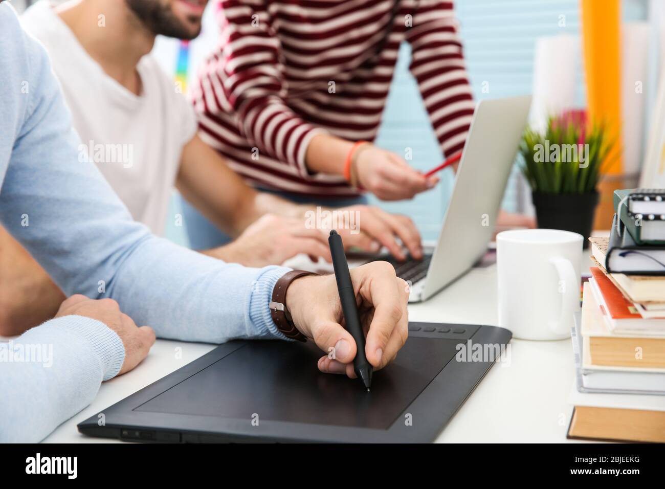 Male hands using graphics tablet Stock Photo - Alamy