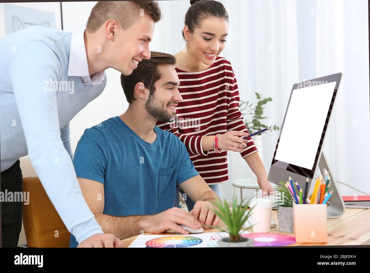 Group of young designers at workplace Stock Photo - Alamy
