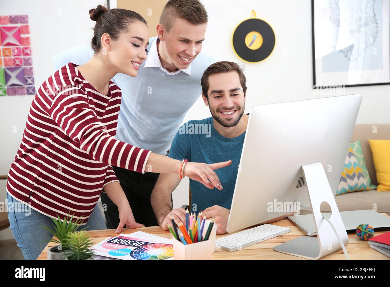 Group of young designers at workplace Stock Photo - Alamy