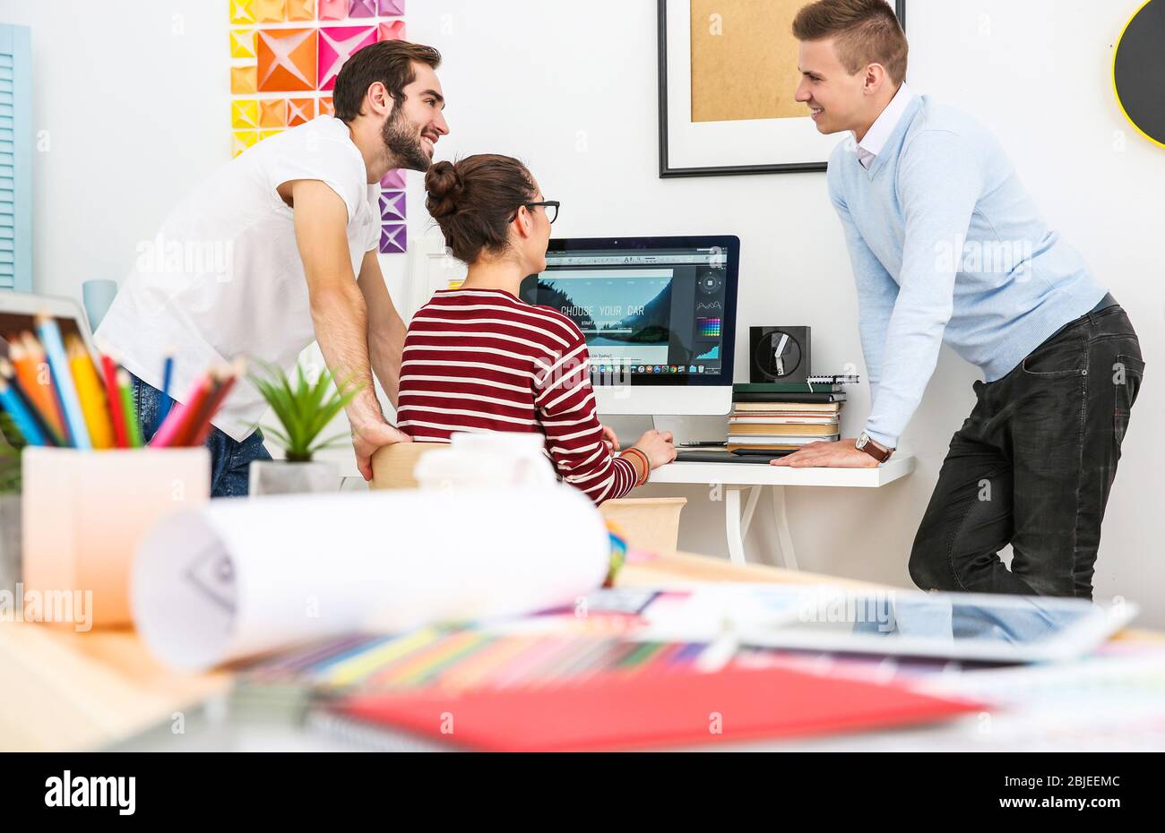 Three young designers at workplace Stock Photo - Alamy