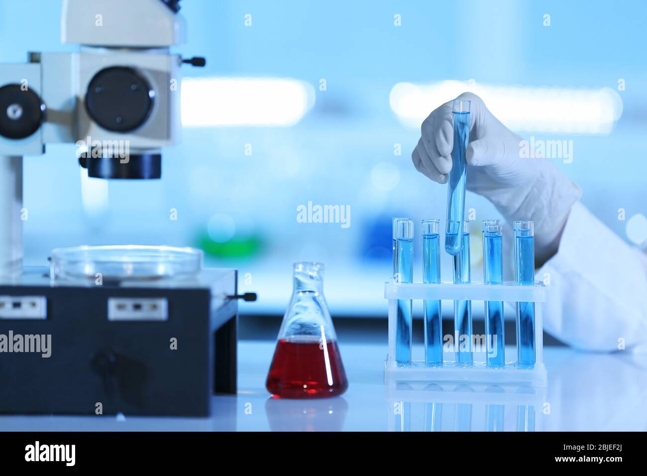 Hand doctor putting test tube hi-res stock photography and images - Alamy