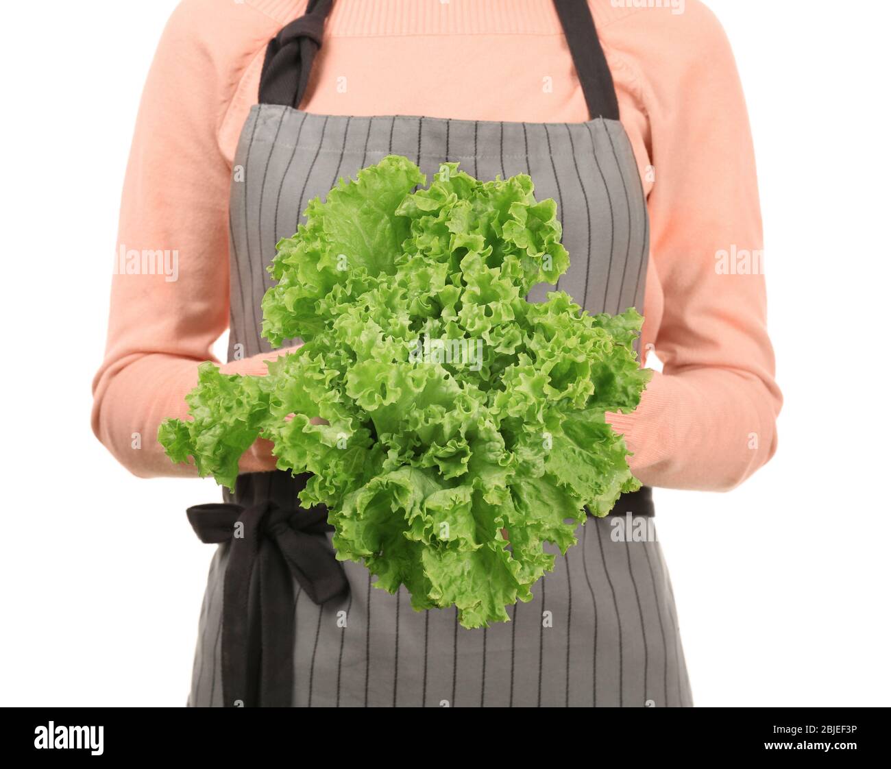 Young woman in apron holding bunch of fresh lettuce, closeup Stock ...