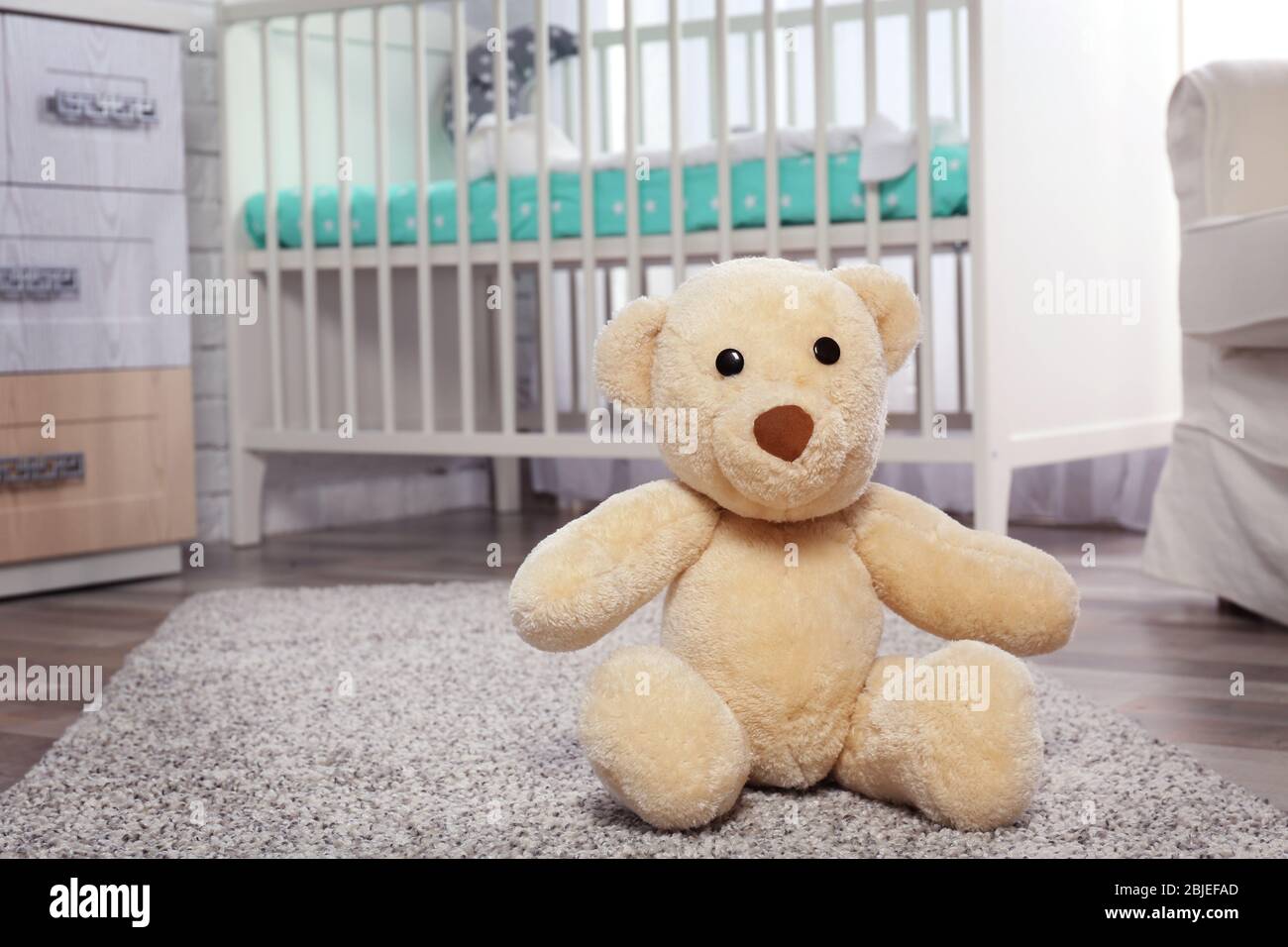 Beautiful teddy bear on the floor in baby room Stock Photo - Alamy