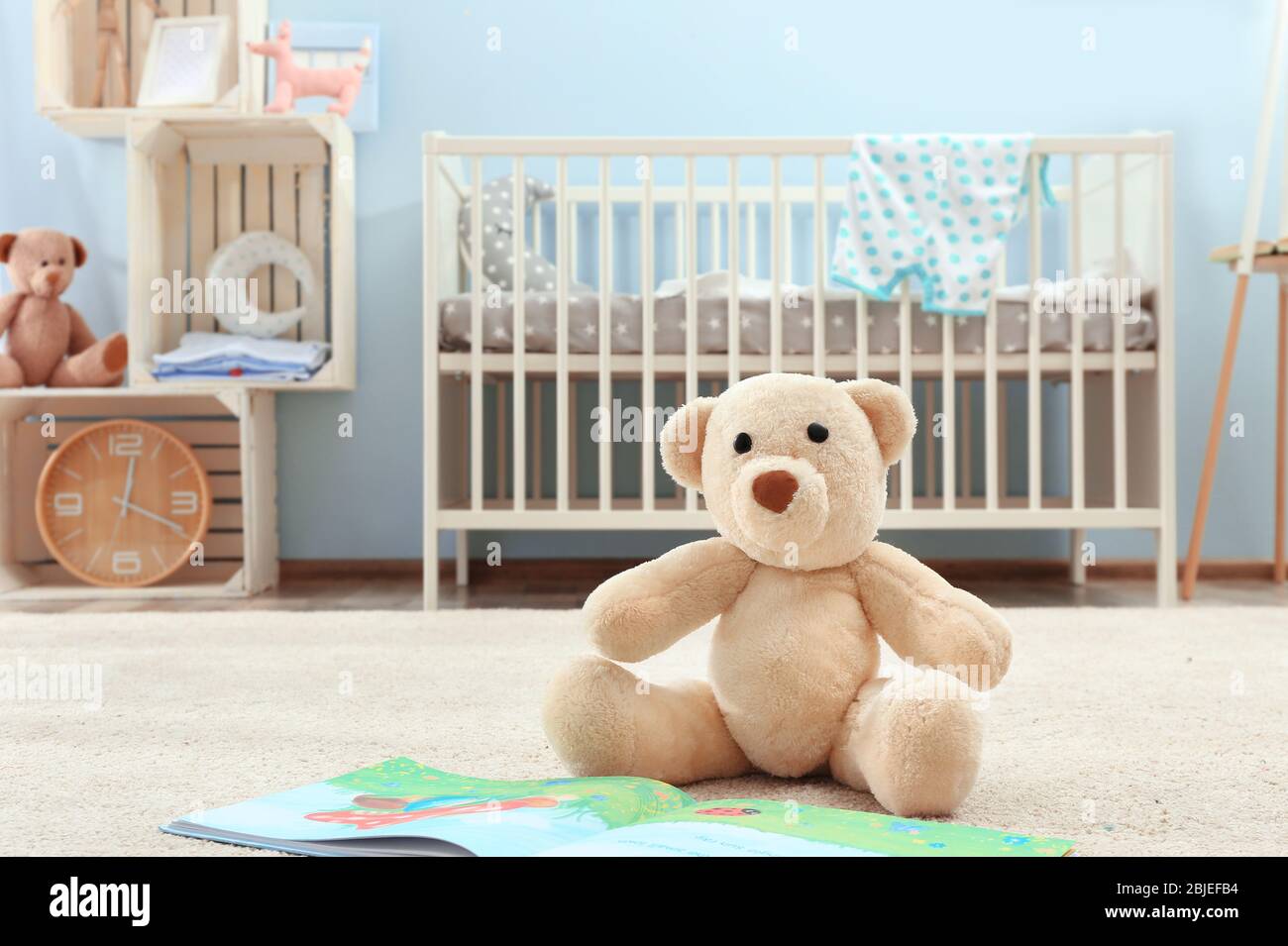 Beautiful teddy bear on the floor in baby room Stock Photo - Alamy