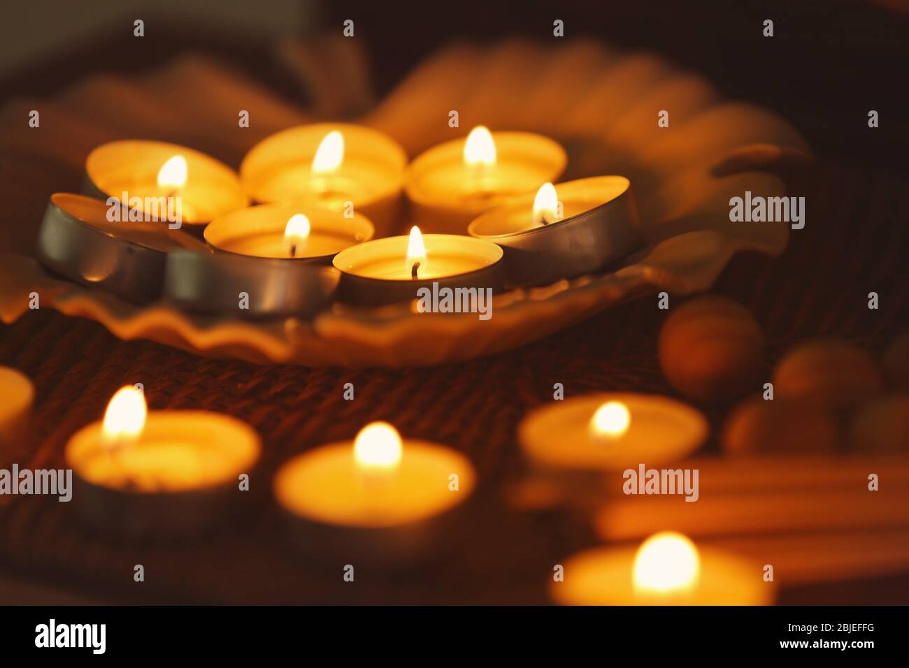 Beautiful composition of alight candles in spa salon Stock Photo - Alamy