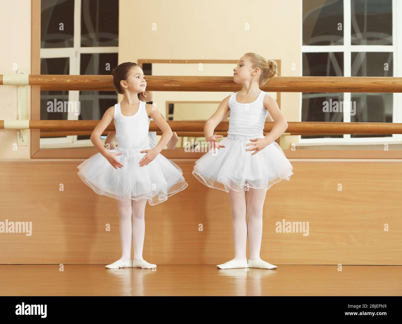 Group of beautiful little girls practicing ballet at class Stock Photo ...