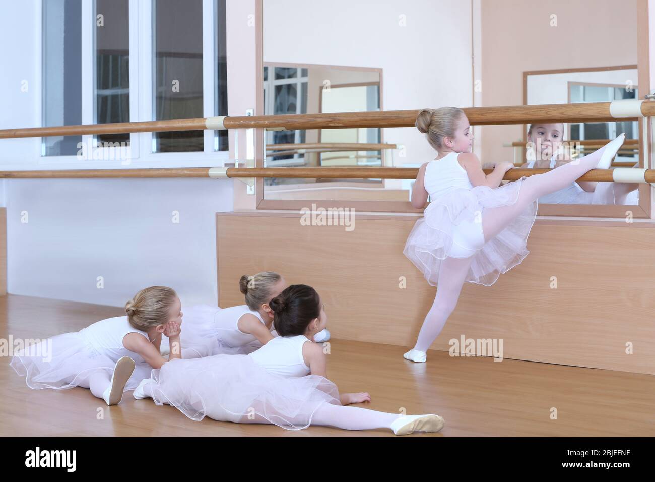 Group of beautiful little girls practicing ballet at class Stock Photo ...