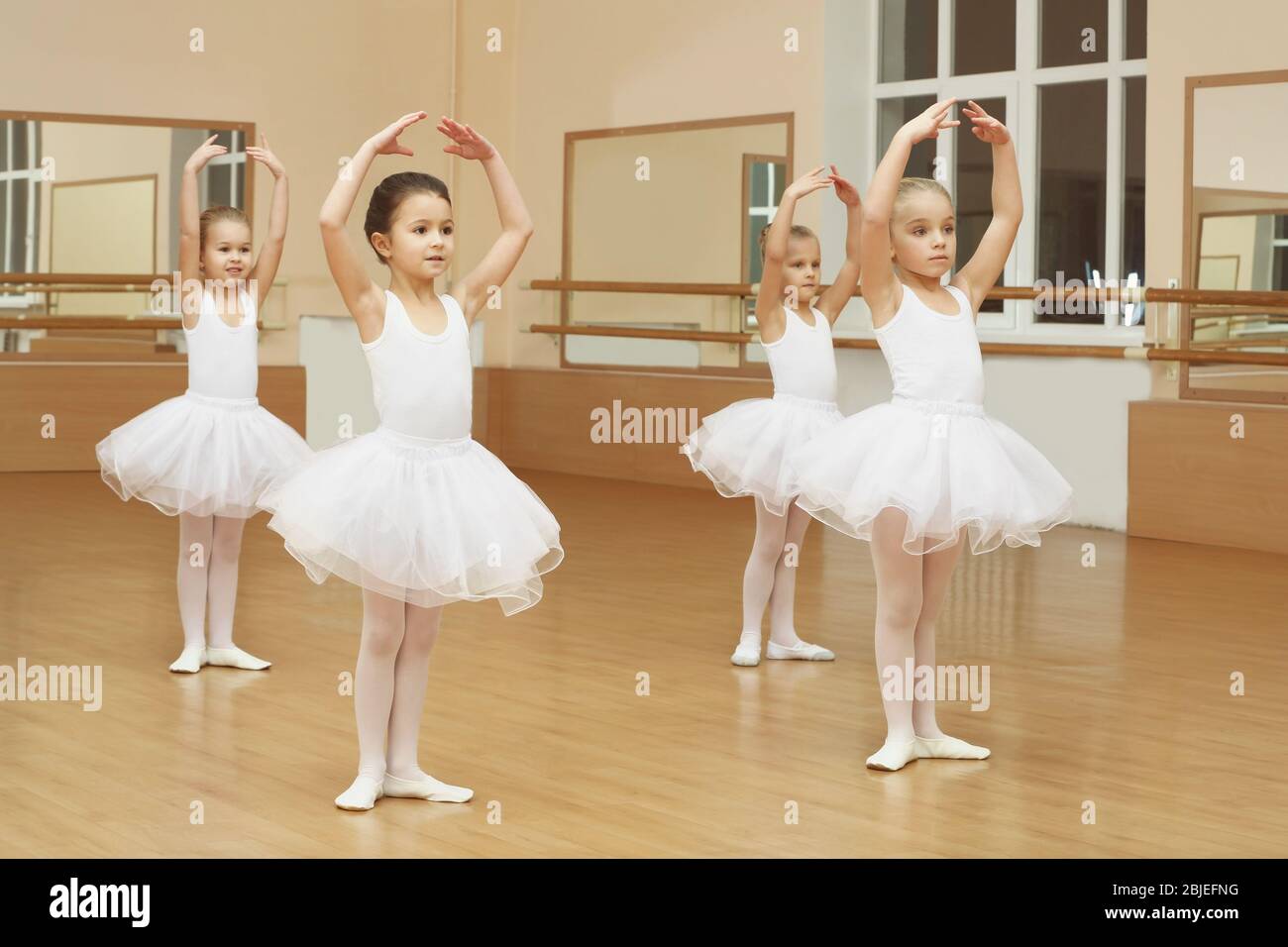 Group of beautiful little girls practicing ballet at class Stock Photo ...