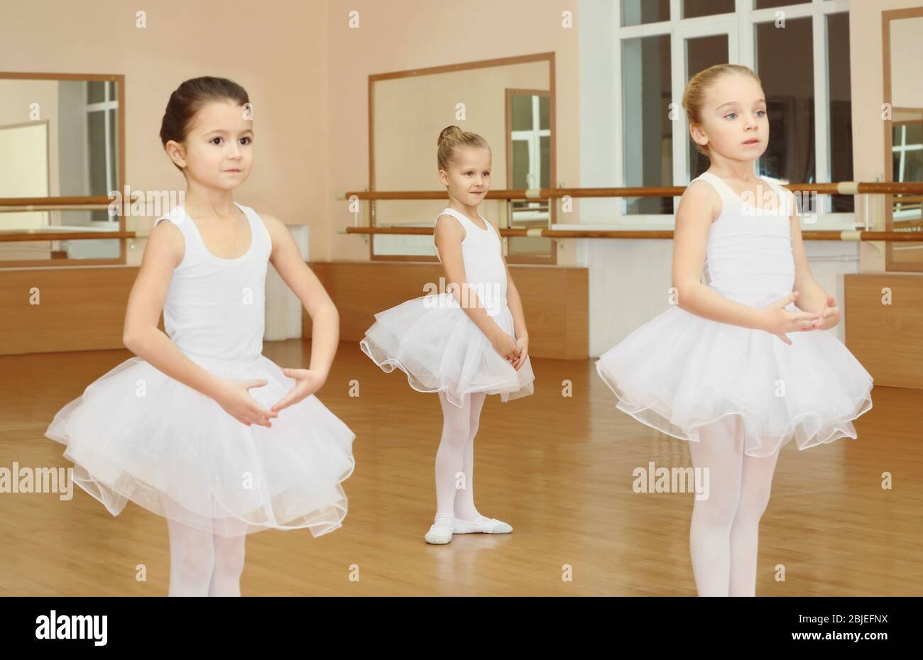 Group of beautiful little girls practicing ballet at class Stock Photo ...
