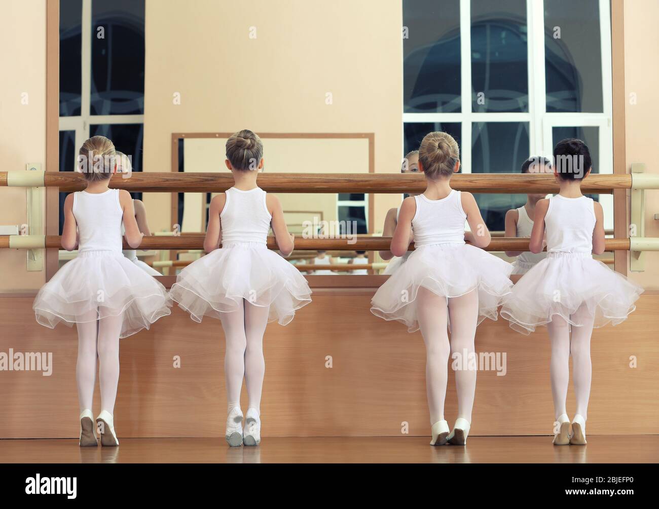 Group of beautiful little girls practicing ballet at class Stock Photo ...