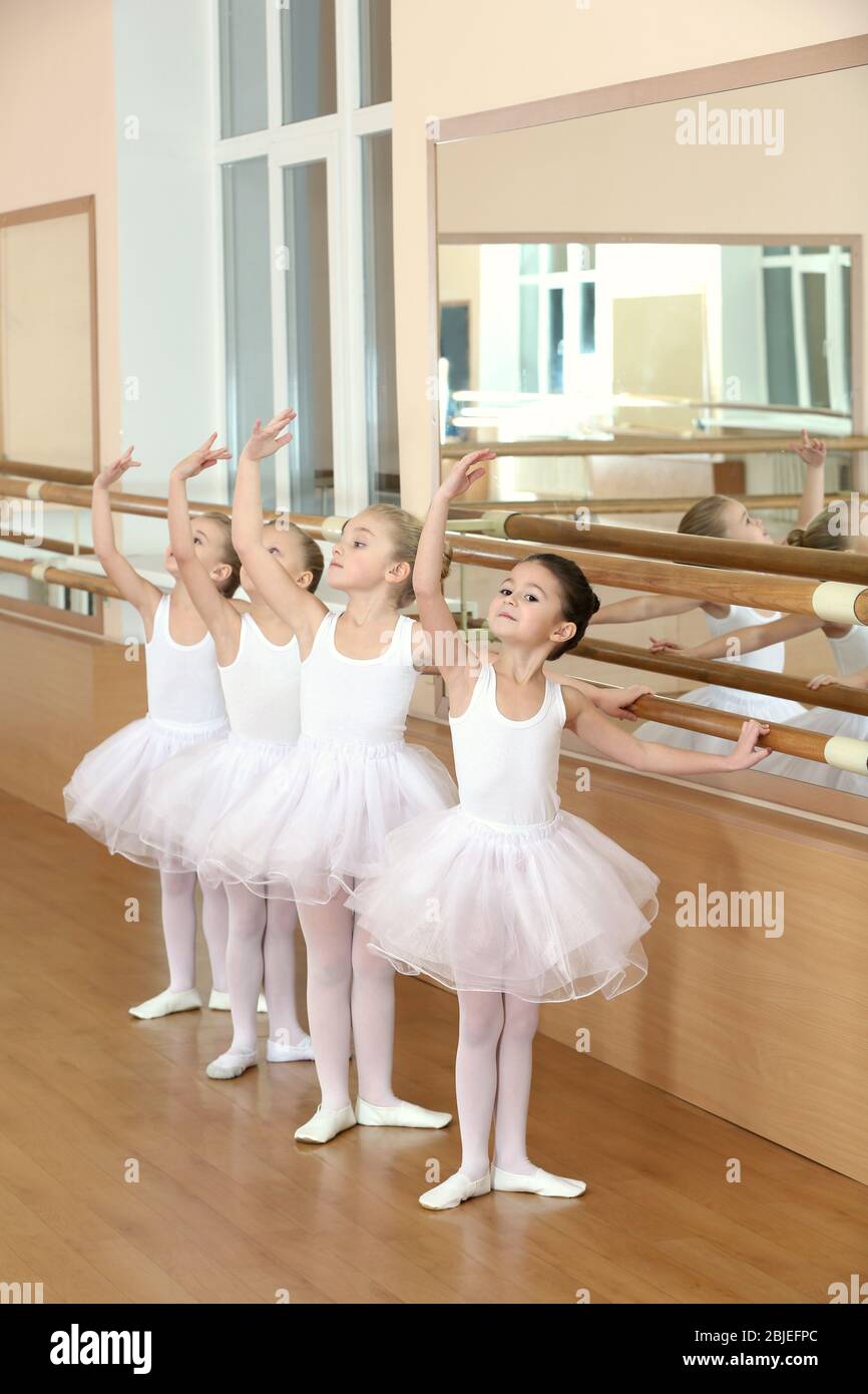 Group of little ballerinas practicing ballet using bar at class Stock ...