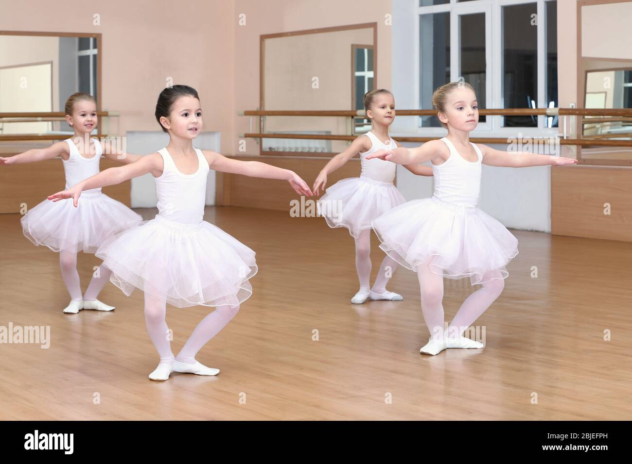Group of beautiful little girls practicing ballet at class Stock Photo ...