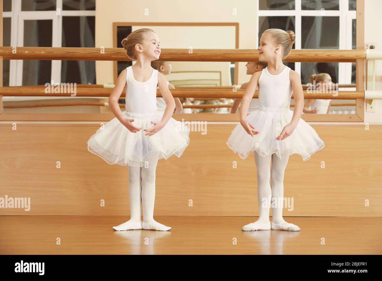 Group of beautiful little girls practicing ballet at class Stock Photo ...
