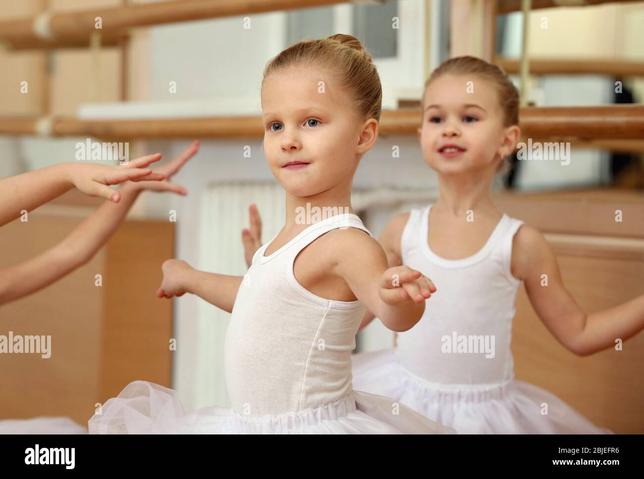 Group of beautiful little girls practicing ballet at class Stock Photo ...