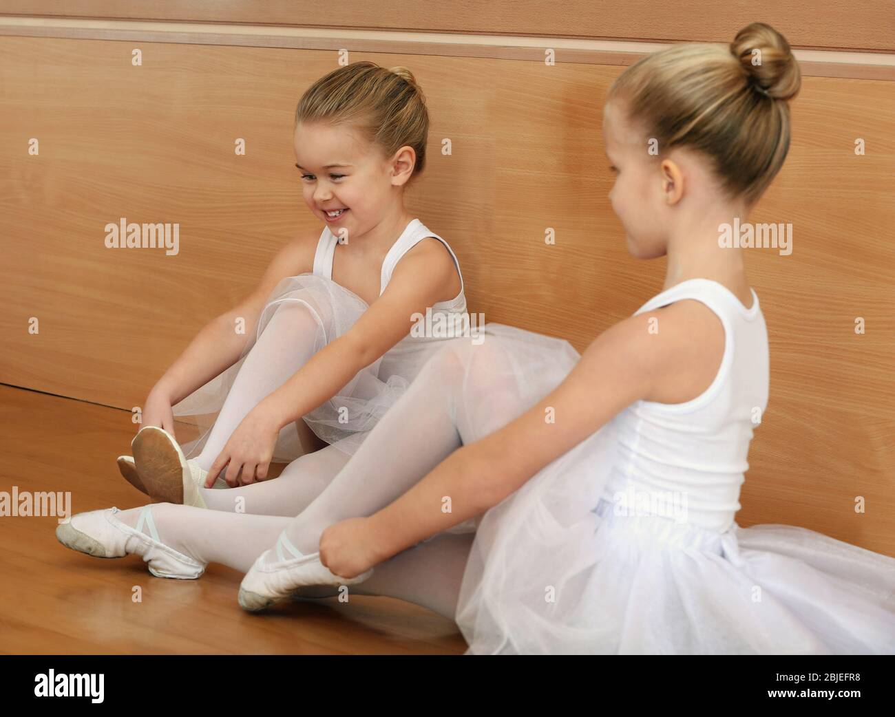 Group of beautiful little ballerinas wearing slippers on the floor ...