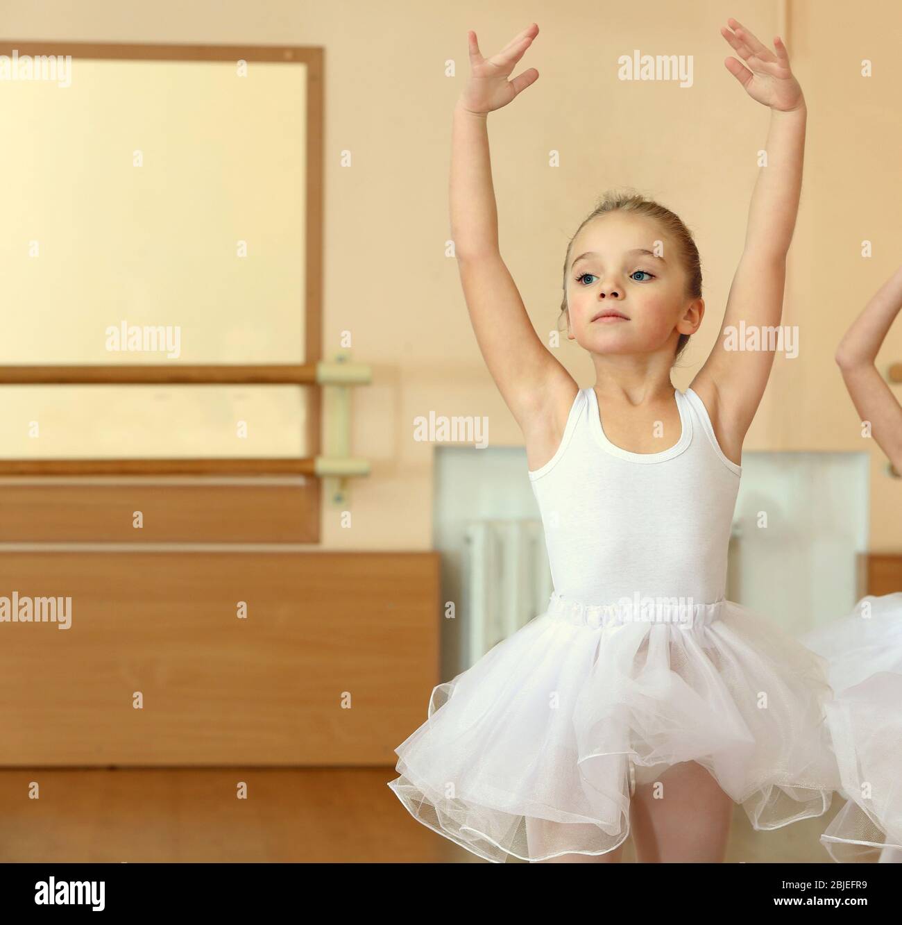Beautiful little girl practicing ballet at class Stock Photo - Alamy