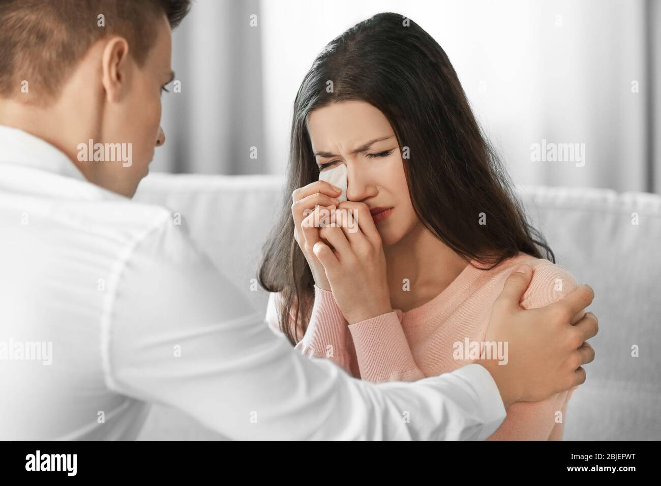 Young depressed crying woman with boyfriend at home Stock Photo - Alamy