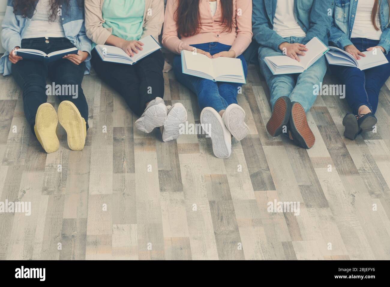 Group of people reading books while sitting on floor Stock Photo - Alamy